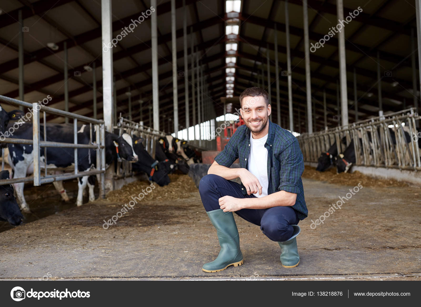 Man or farmer with cows in cowshed on dairy farm — Stock Photo © Syda ...