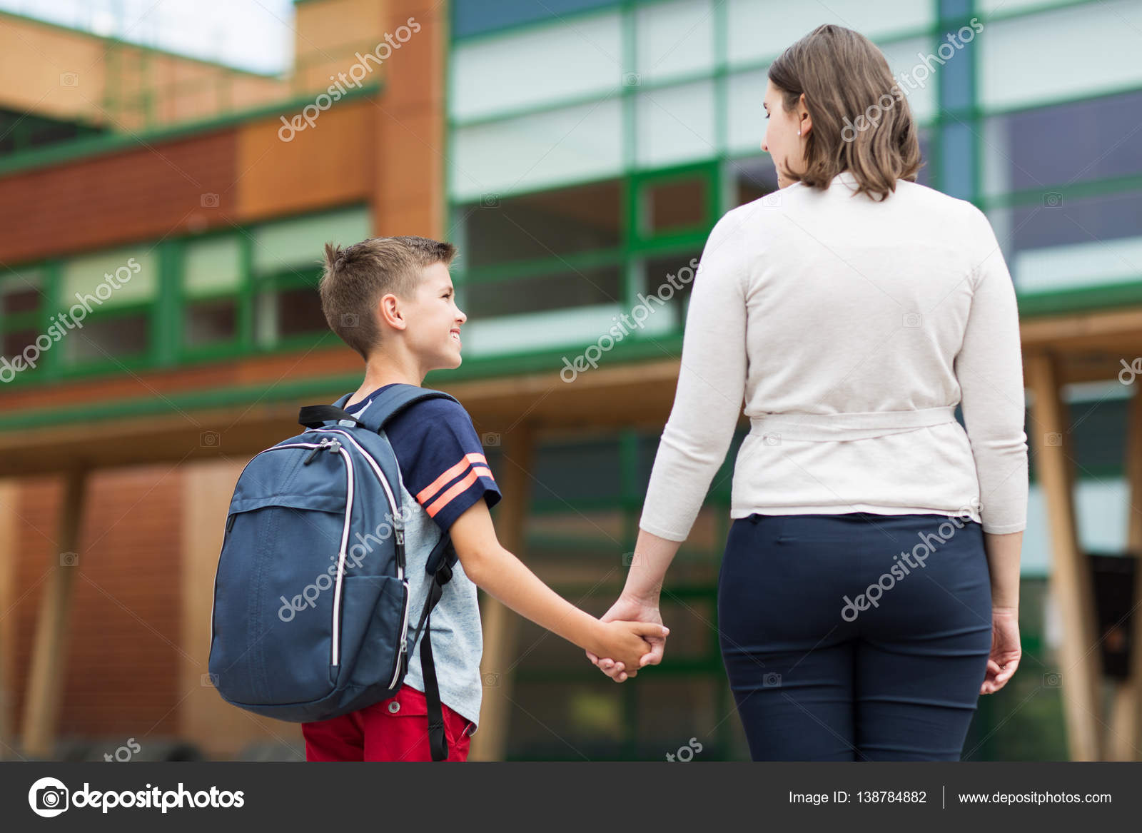 Elementary student boy with mother at school yard Stock Photo by ©Syda ...