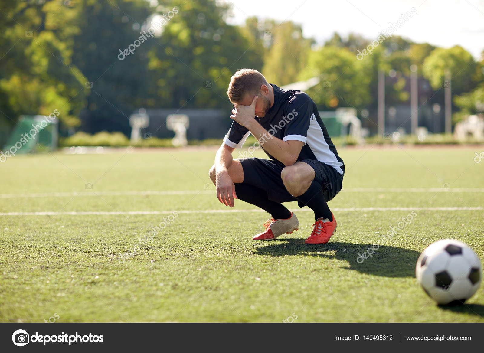 Sad soccer player with ball on football field — Stock Photo © Syda ...