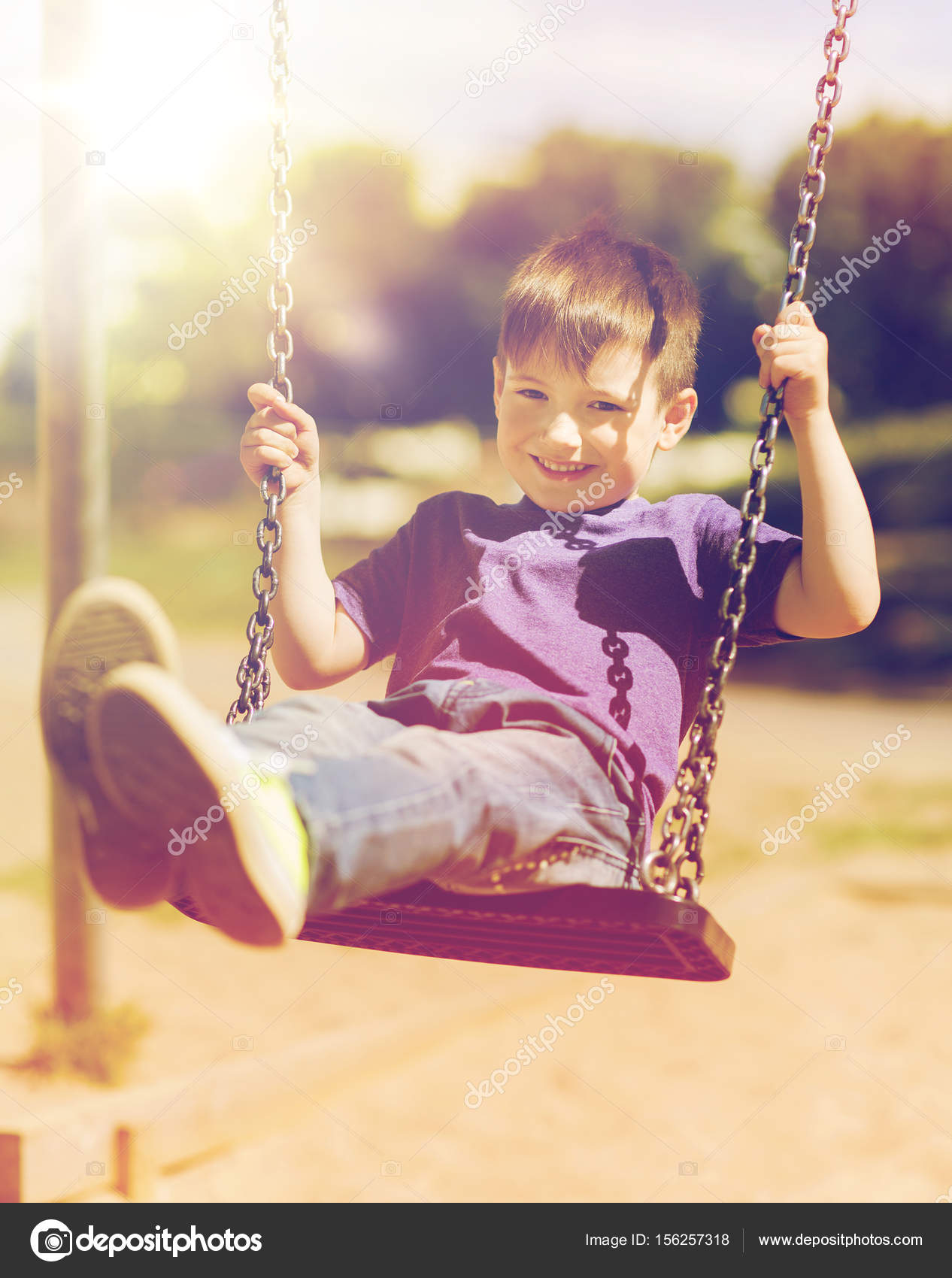 Happy little boy swinging on swing at playground — Stock Photo © Syda ...