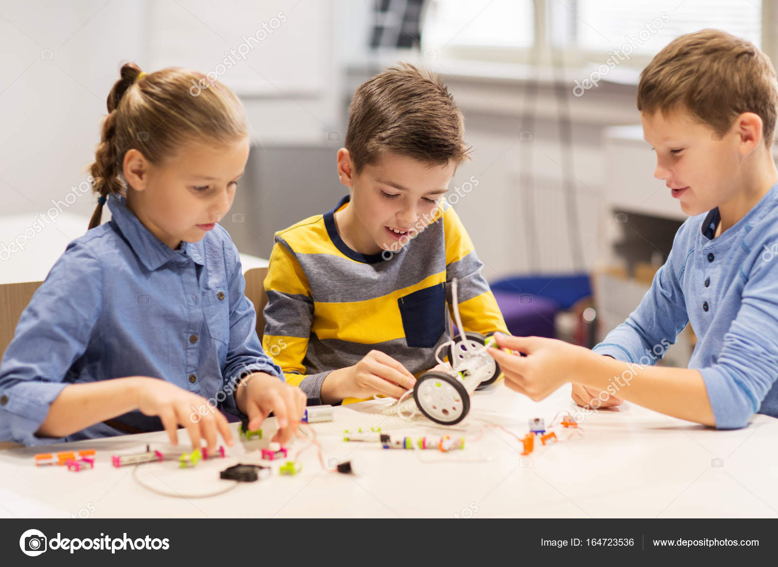 Happy children building robots at robotics school Stock Photo by ©Syda ...