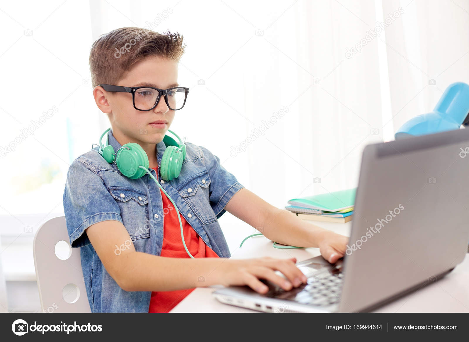 Student boy in glasses typing on laptop at home — Stock Photo © Syda ...