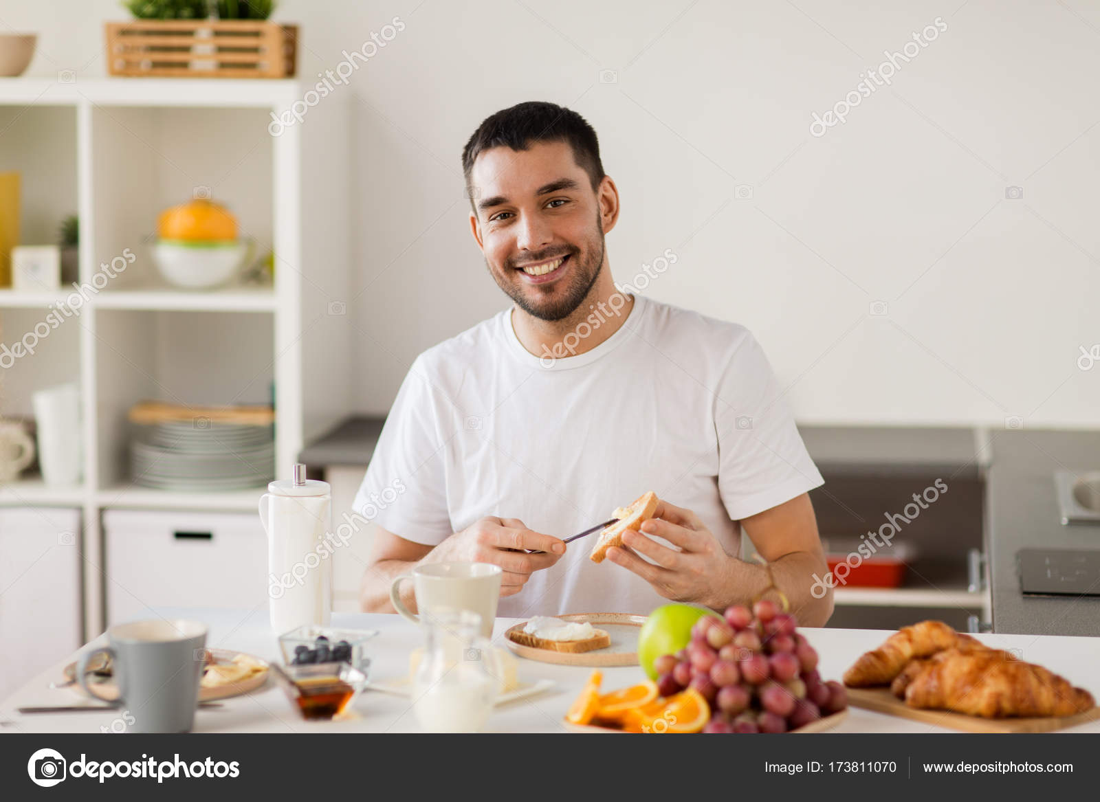 Man eating toast with coffee at home kitchen Stock Photo by ©Syda ...