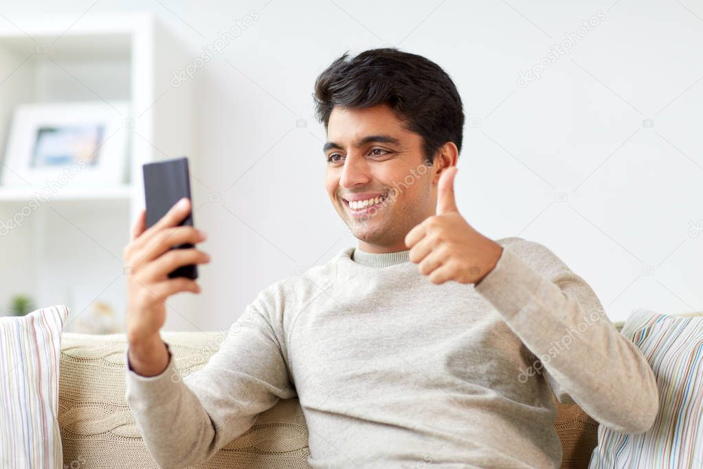Happy man having video call on smartphone at home — Stock Photo © Syda ...