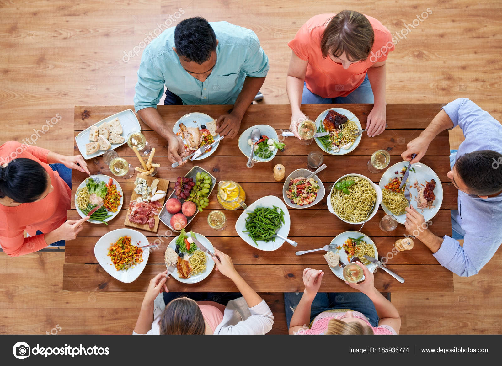Group of people eating at table with food Stock Photo by ©Syda ...