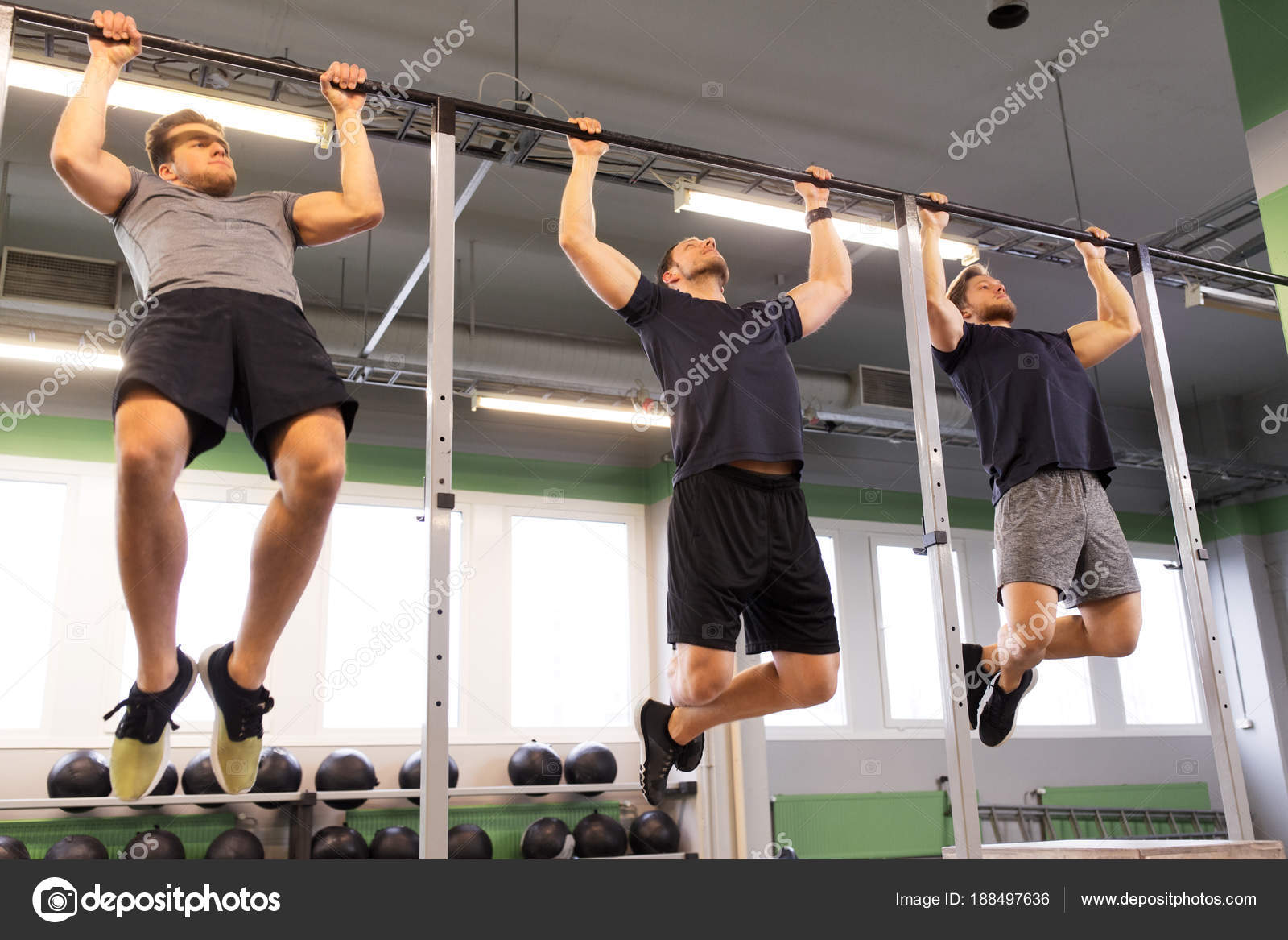Group of young men doing pull-ups in gym Stock Photo by ©Syda ...