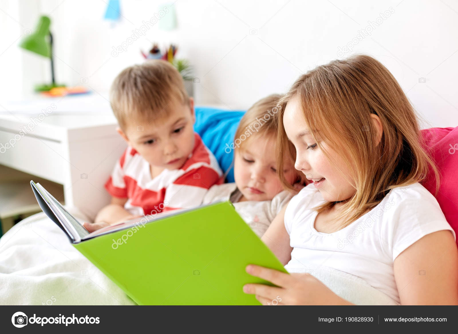 Little kids reading book in bed at home Stock Photo by ©Syda ...