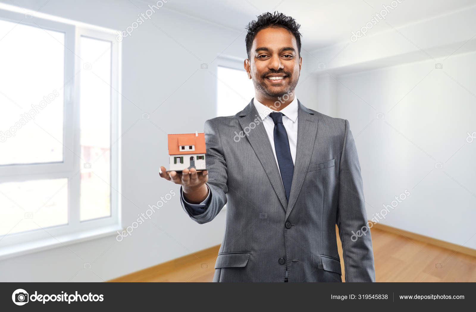 Indian man realtor with house model at new home — Stock Photo © Syda ...