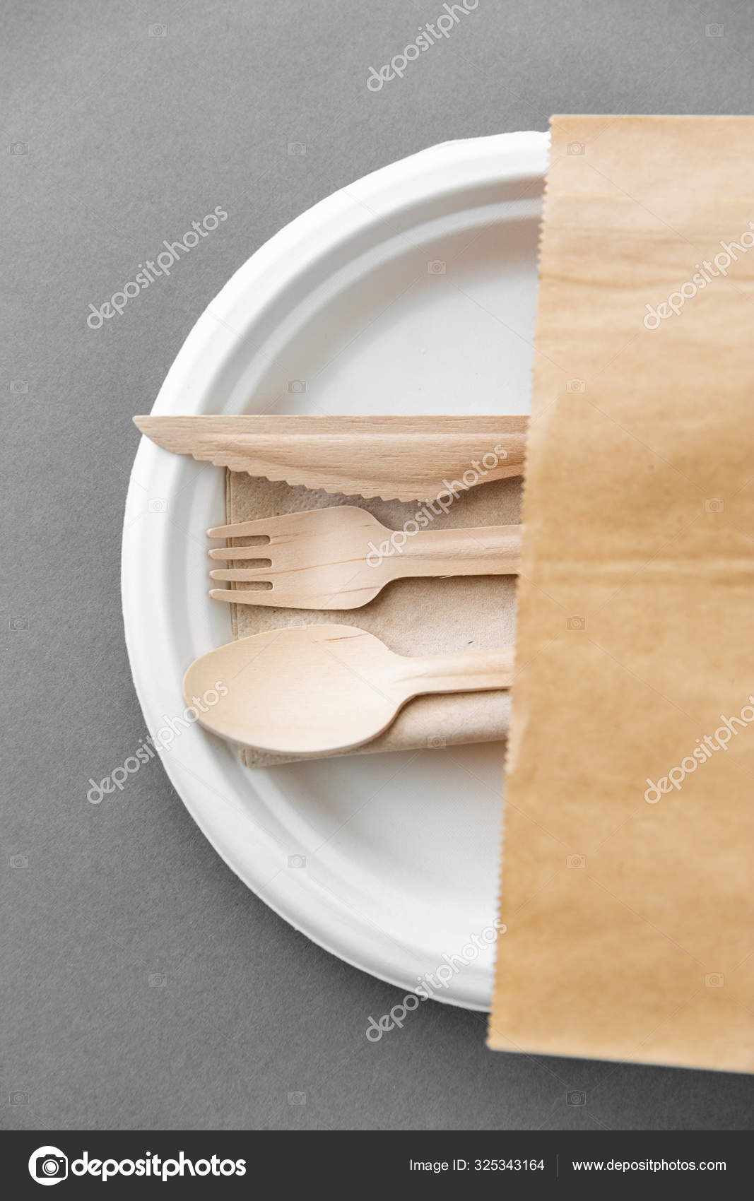 Wooden spoon, fork and knife on paper plate Stock Photo by ©Syda ...