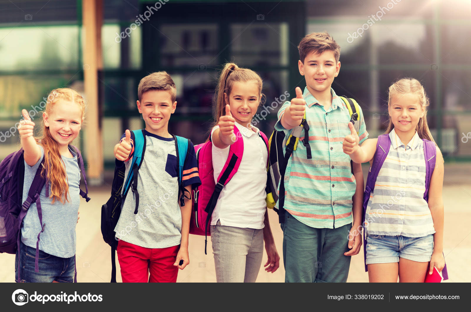Happy elementary school students showing thumbs up — Stock Photo © Syda ...