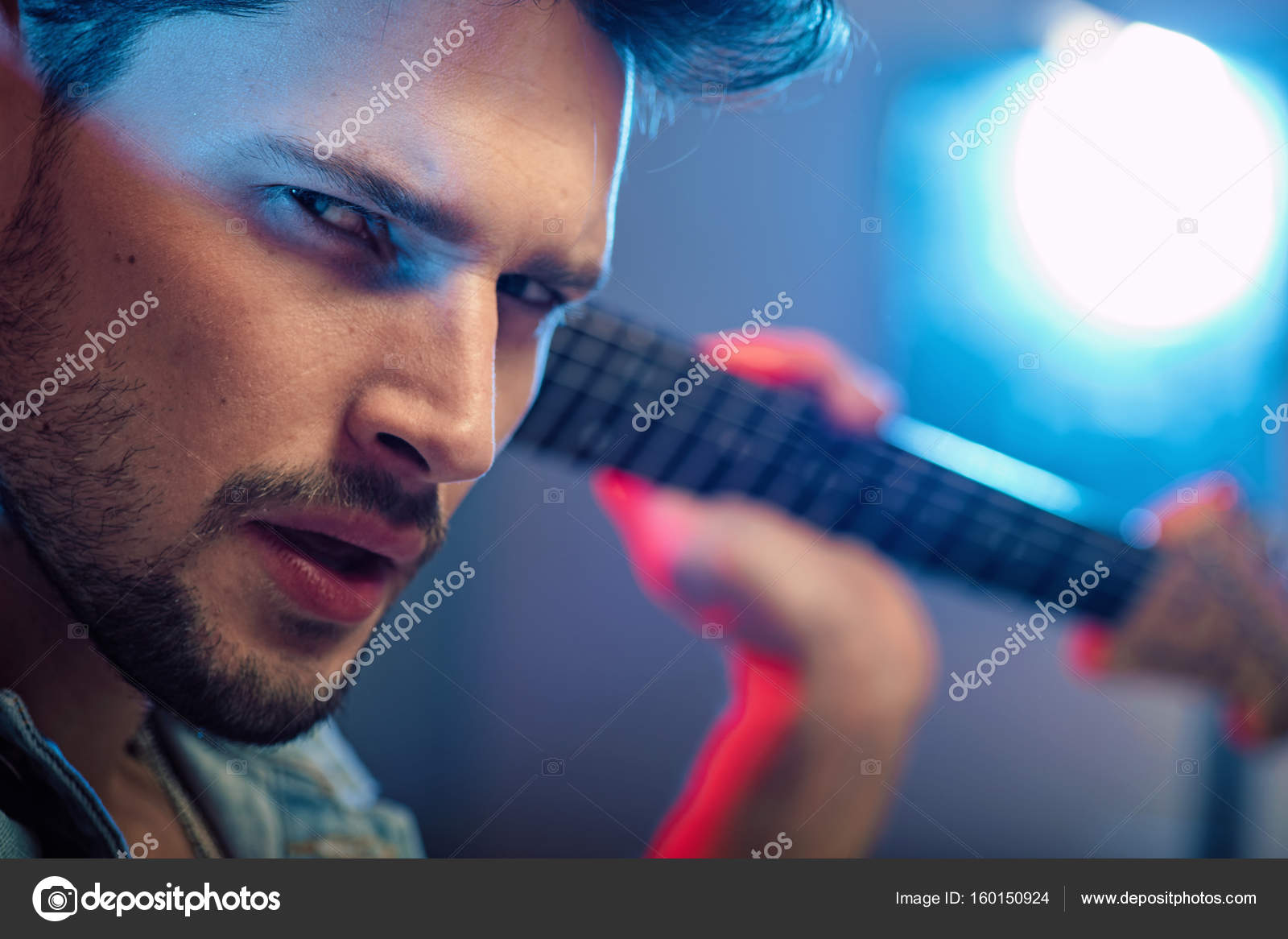 Portrait of a serious, handsome guitarist Stock Photo by ©konradbak ...