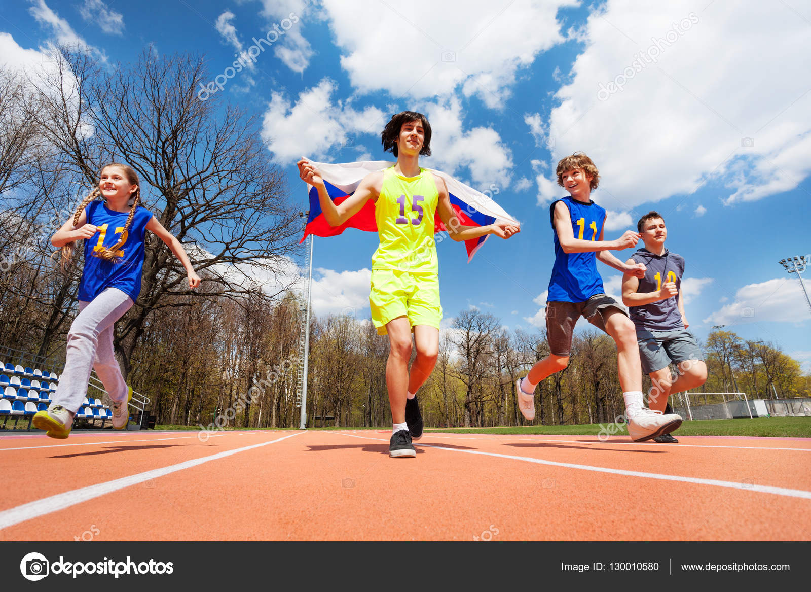 Russian sprinters running on stadium Stock Photo by ©serrnovik 130010580