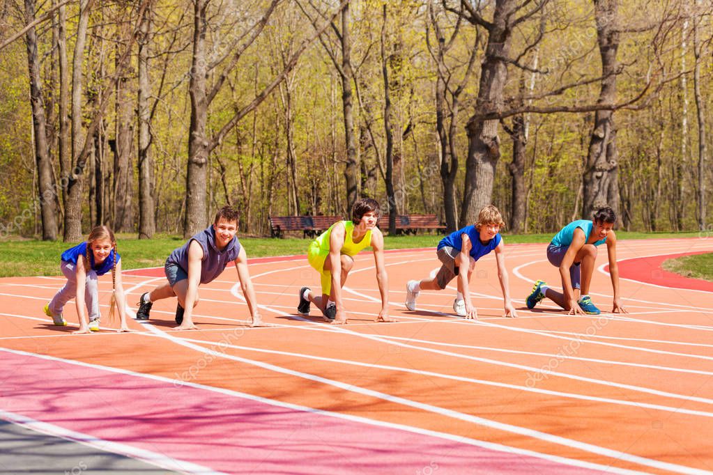 Athletes preparing to start running Stock Photo by ©serrnovik 130011966
