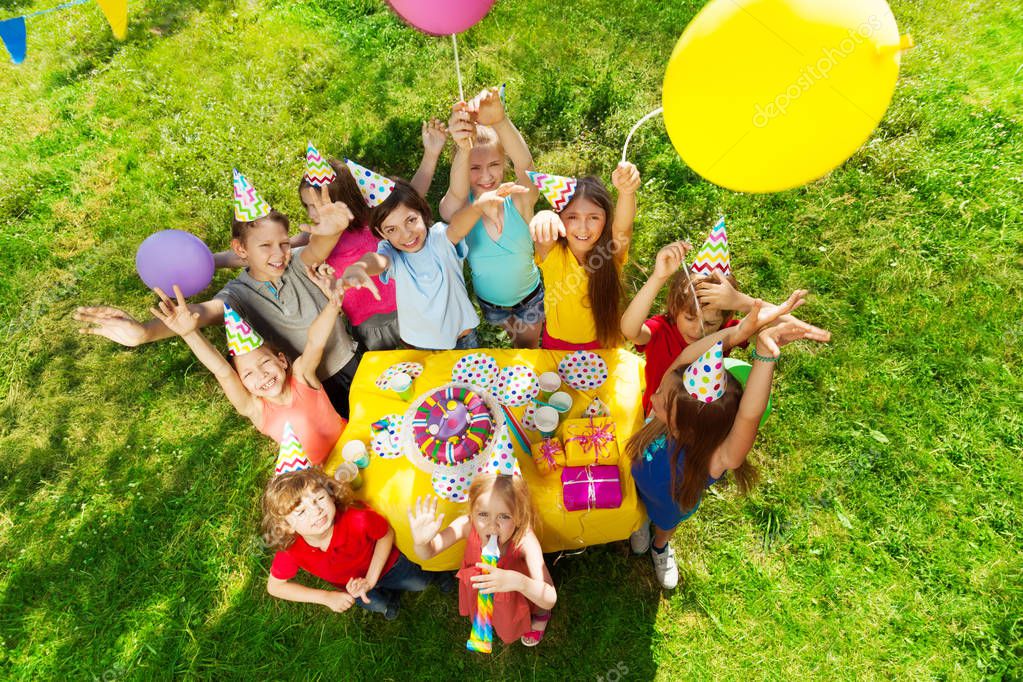 Kids celebrating birthday in park Stock Photo by ©serrnovik 130012370