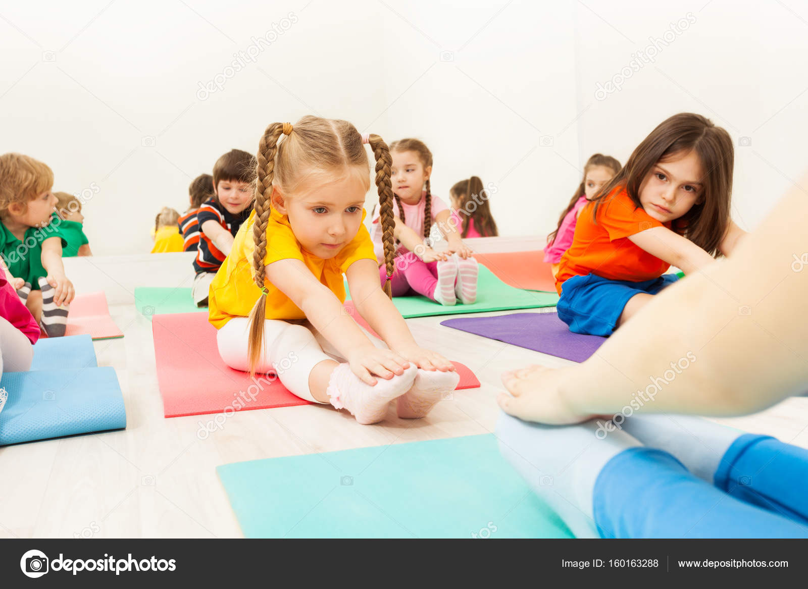 Happy kids practicing gymnastic Stock Photo by ©serrnovik 160163288