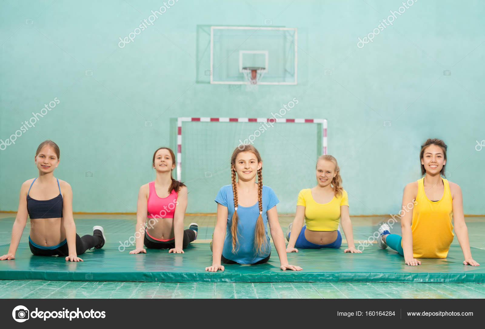 Girls stretching back laying on mat Stock Photo by ©serrnovik 160164284