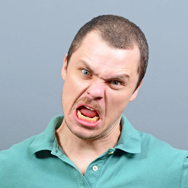 Portrait of a angry man screaming against gray background Stock Photo ...