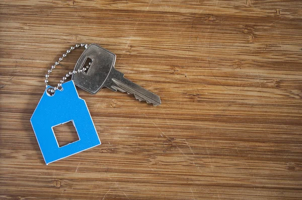House-shaped key in the wood - Stock Image - Everypixel