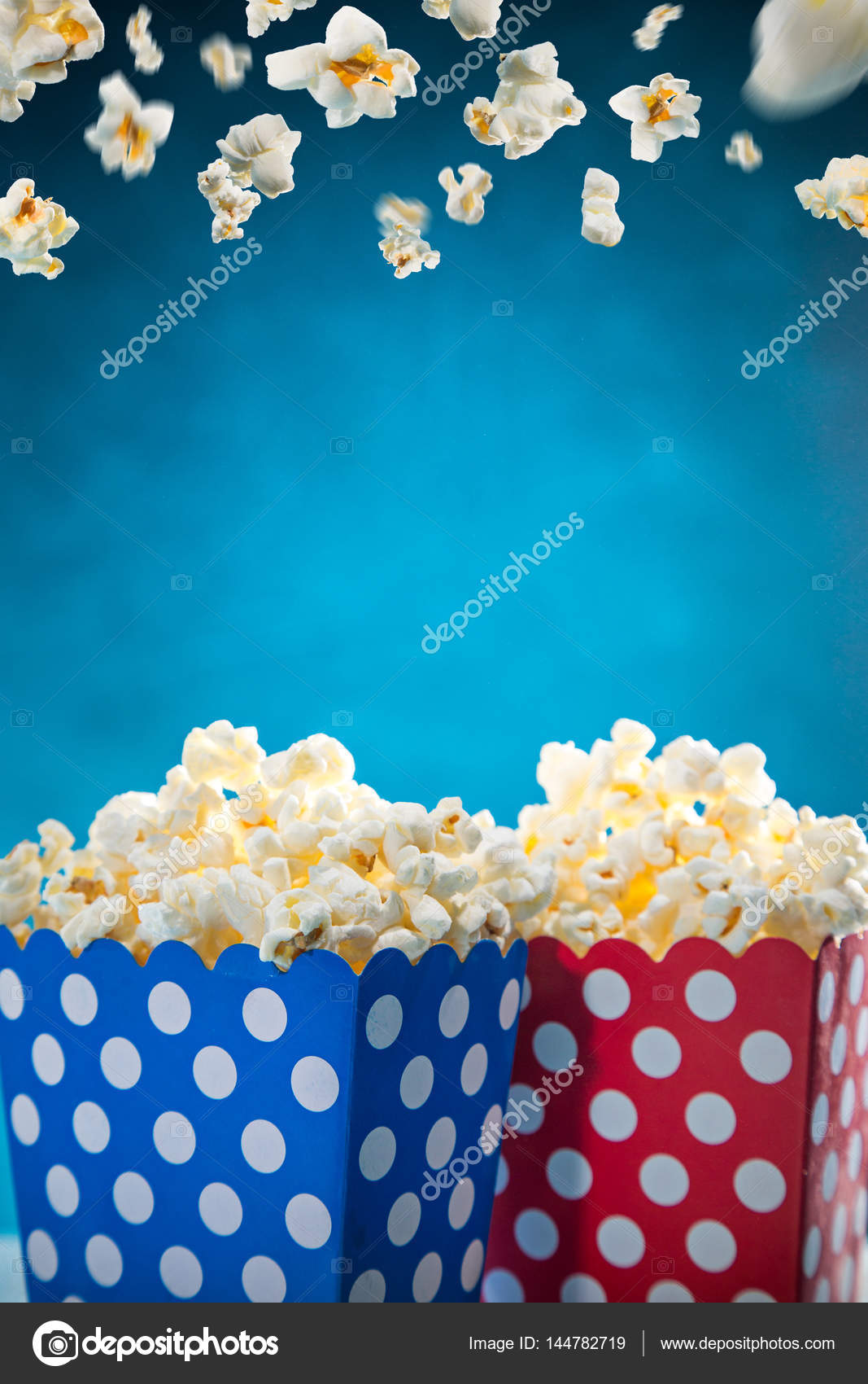 Boxes of popcorn on blue background. Stock Photo by ©Kesu01 144782719