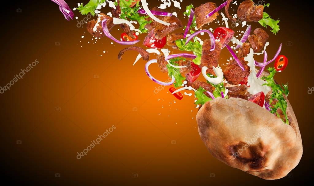 Sandwich de kebab con ingredientes voladores. 2024