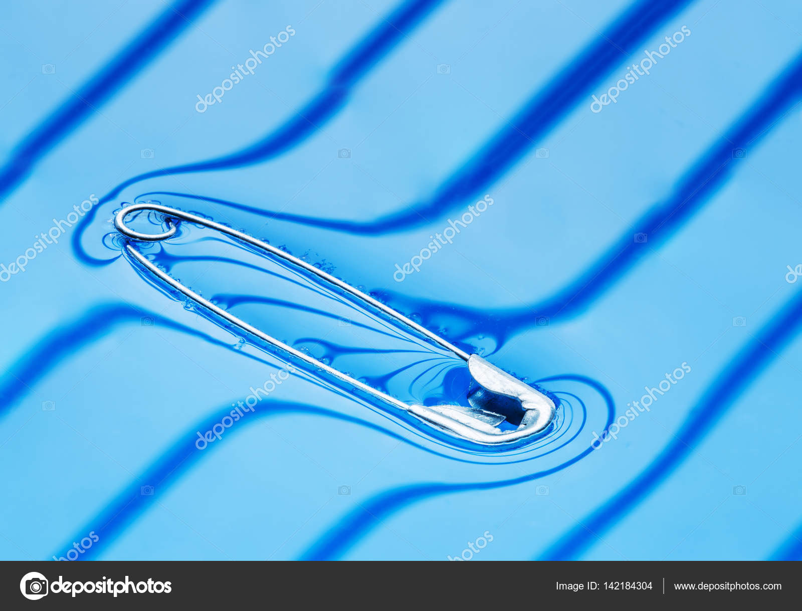 Physical experiment - pin floating on water surface. Stock Photo by ...