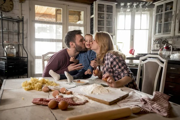 Happy family making pasta in the kitchen at home - Stock Image - Everypixel