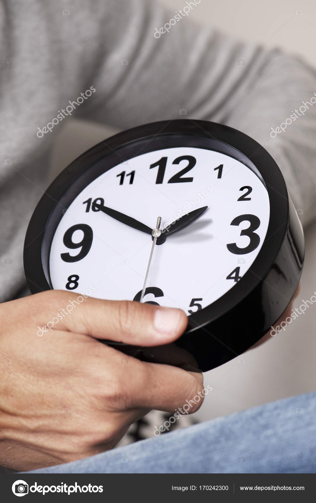 Man adjusting the time of a clock Stock Photo by ©nito103 170242300