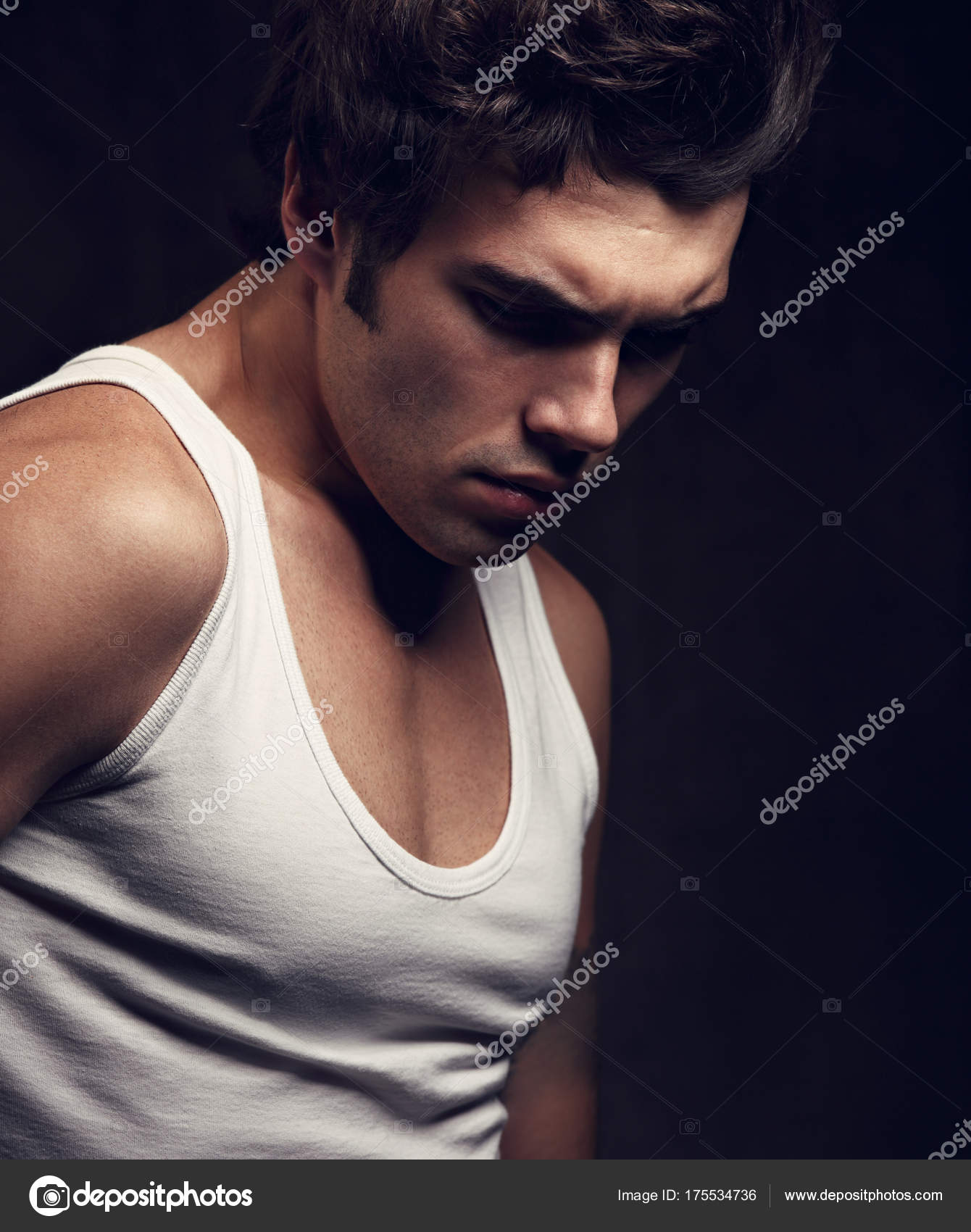 Sexy strong sad handsome man posing in white t-shirt and looking Stock ...
