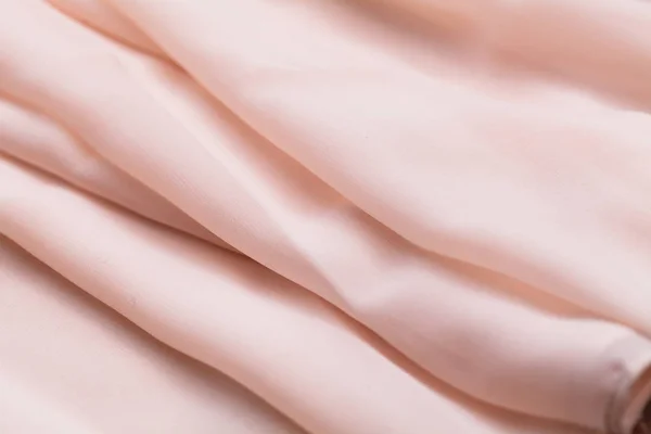 Pink light cloth, fabric, textile with a lot of folds, plaits , creases ...