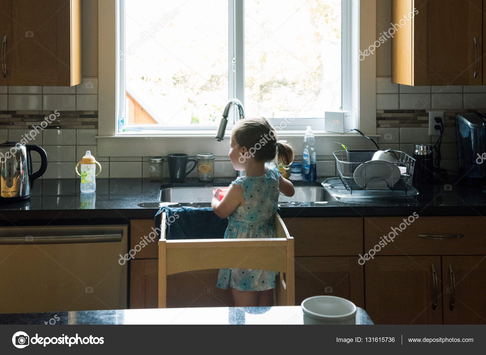 Young Girl Playing Kitchen Sink While Helping Dishes Stock Photo by ...