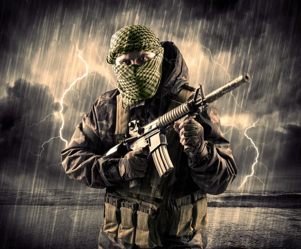 Dangerous armed terrorist with mask and gun in a thunderstorm wi Stock ...