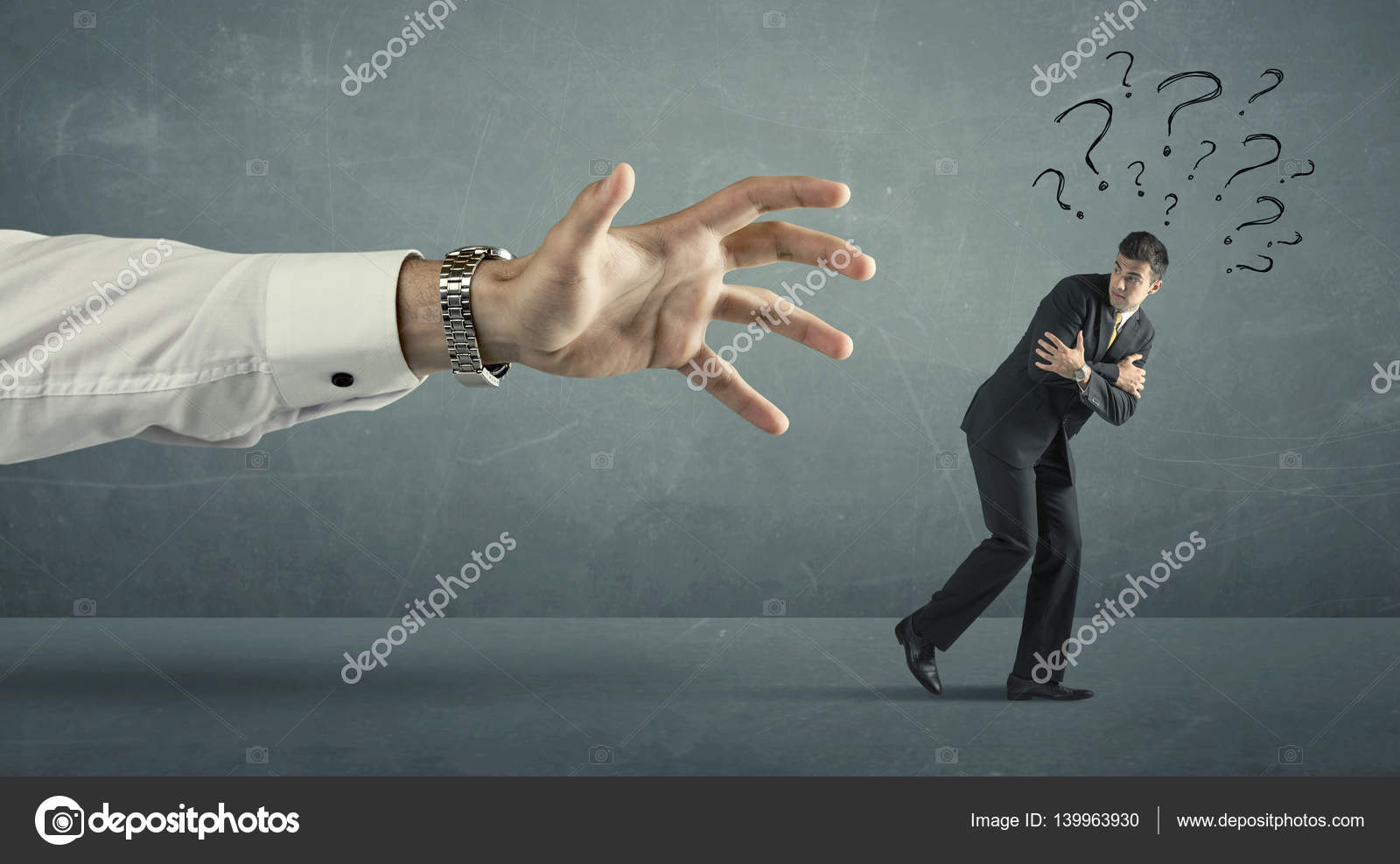 Businessman with question marks running away from a big hand Stock ...