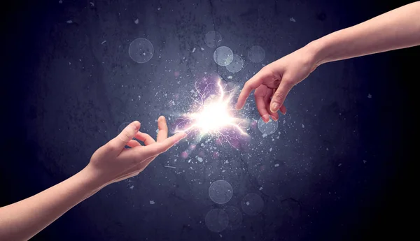 Hands reaching to light a spark Stock Photo by ©ra2studio 179016950