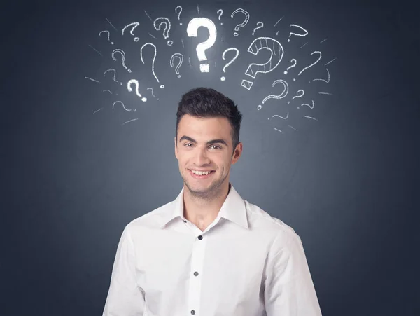 Fotos de Joven empresario que presenta signos de interrogación ...