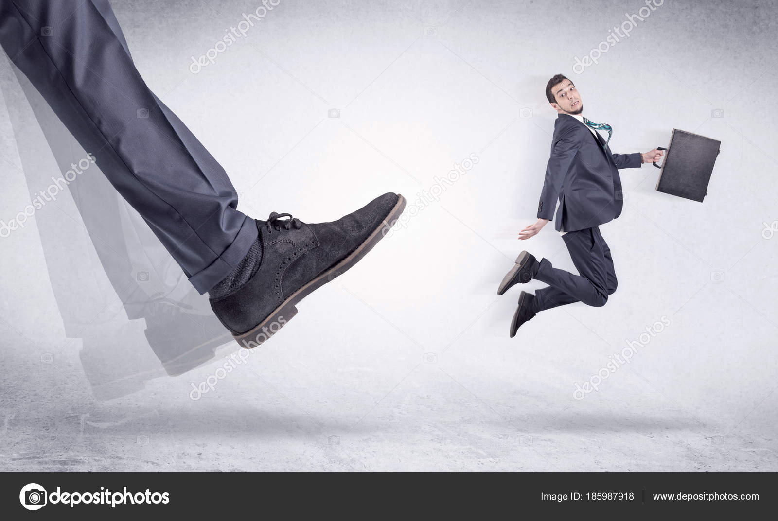 Black shoe kicking small man — Stock Photo © ra2studio #185987918