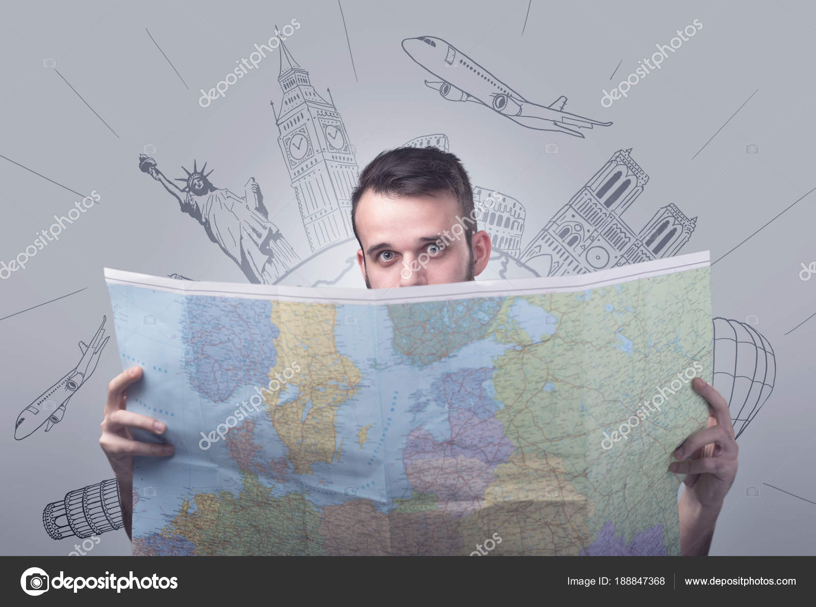Young man holding map Stock Photo by ©ra2studio 188847368