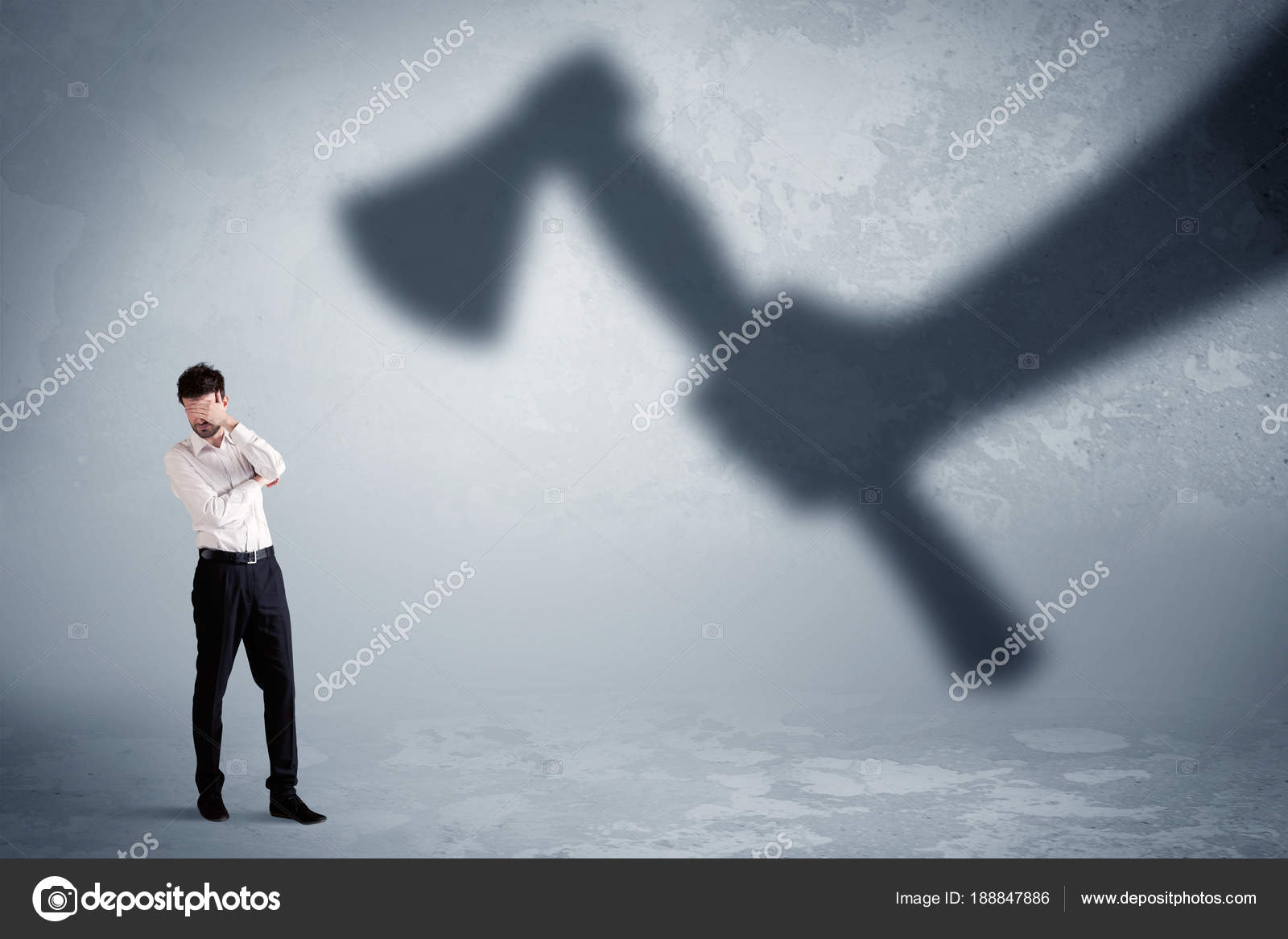 Businessman afraid of a huge shadow hand holding an axe concept Stock ...