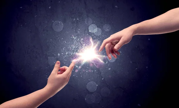 Hands reaching to light a spark - Stock Image - Everypixel
