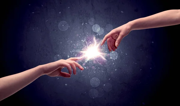 Hands reaching to light a spark - Stock Image - Everypixel