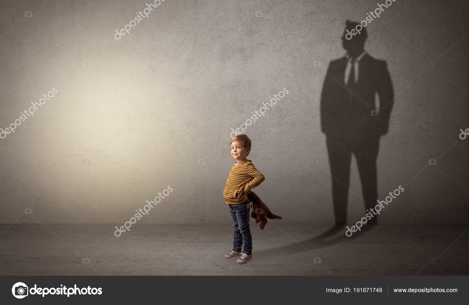 Little boy with businessman shadow Stock Photo by ©ra2studio 191871748