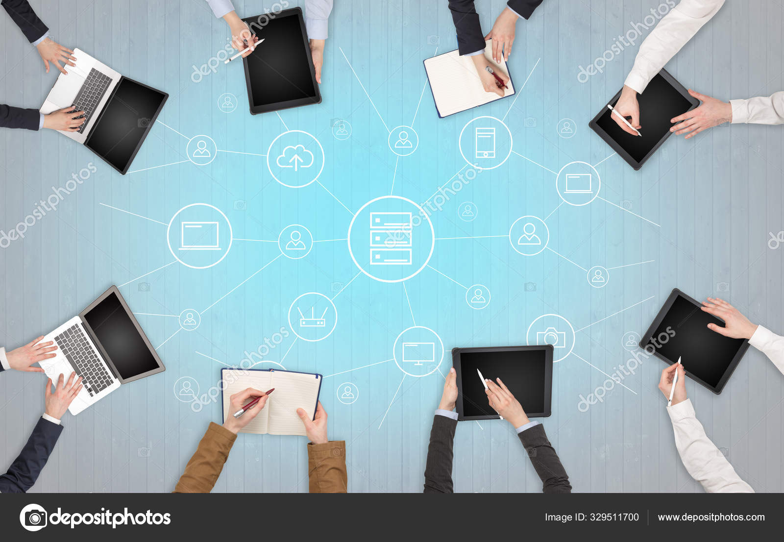 Group of people with devices in hands working on laptops and tablets ...