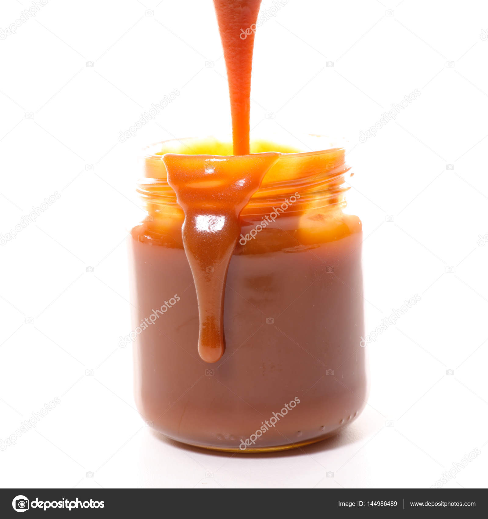 Pouring liquid caramel in jar Stock Photo by ©studioM 144986489