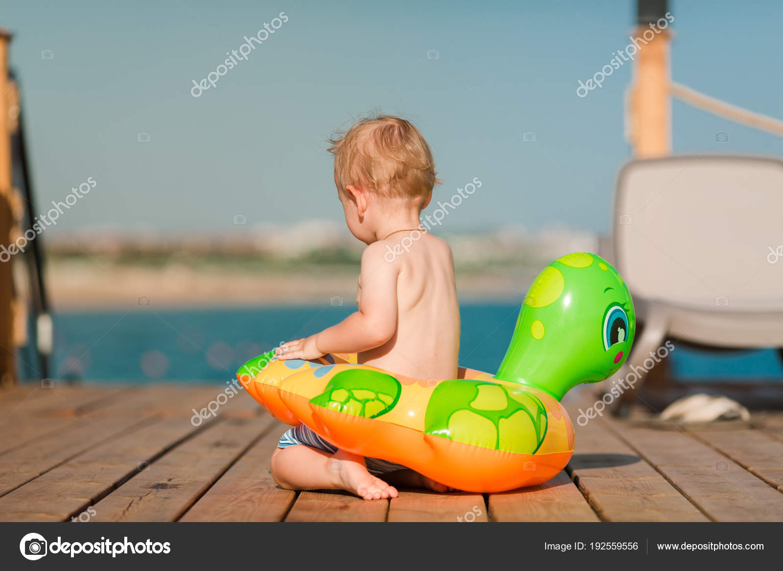 Cute little boy playing with life buoy at the seaside Stock Photo by ...
