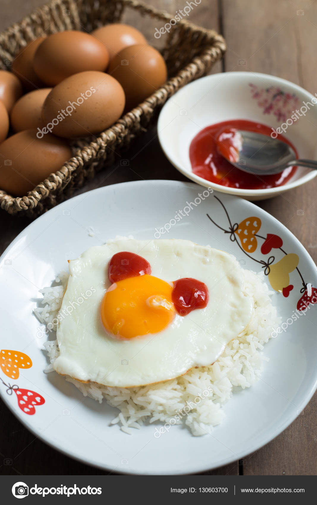 Fried egg on cooked rice and fresh eggs. Stock Photo by ©ibrave 130603700