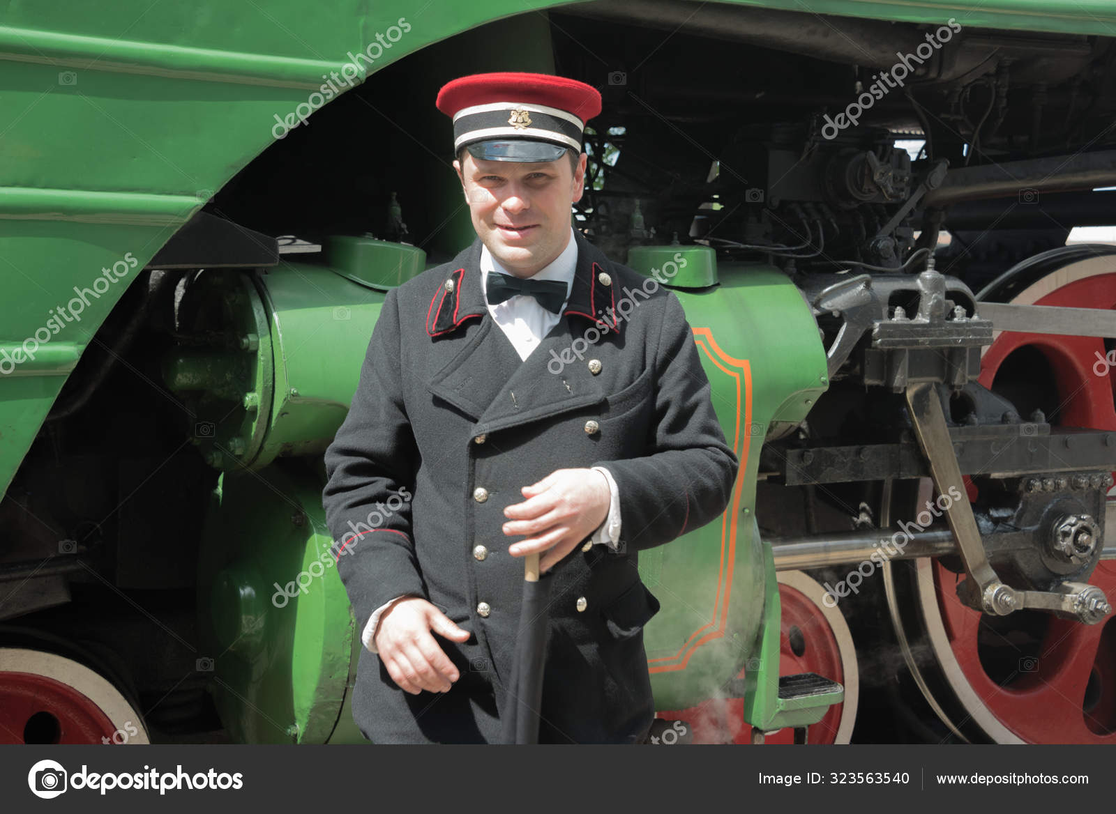 Smiling train conductor at platform of Rizhsky railway station o ...