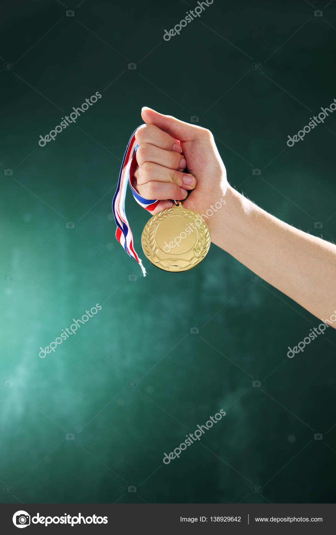 Hand holding medal Stock Photo by ©eskaylim 138929642