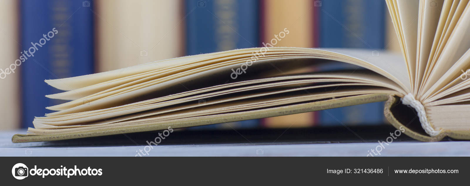 Open book, hardback books on wooden table. Back to school. Copy space ...