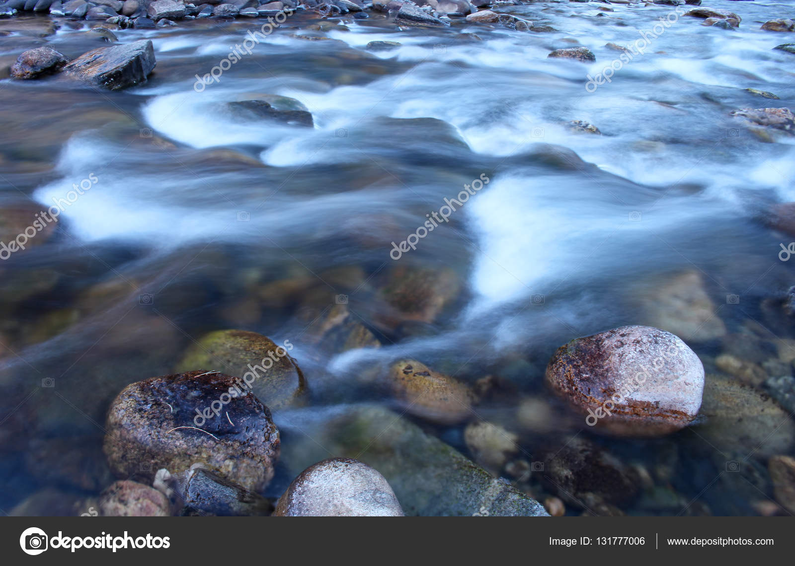 Water flows over rocks in the river — Stock Photo © DanRoss #131777006