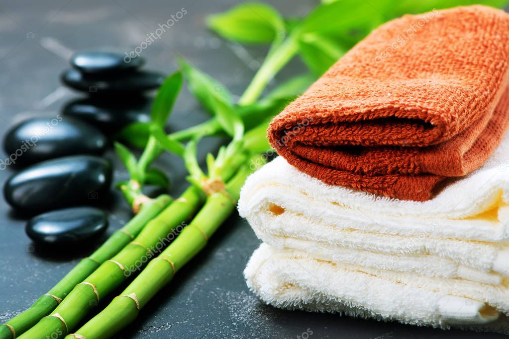 Clear towels, black stones and bamboo on a table — Stock Photo © tycoon ...