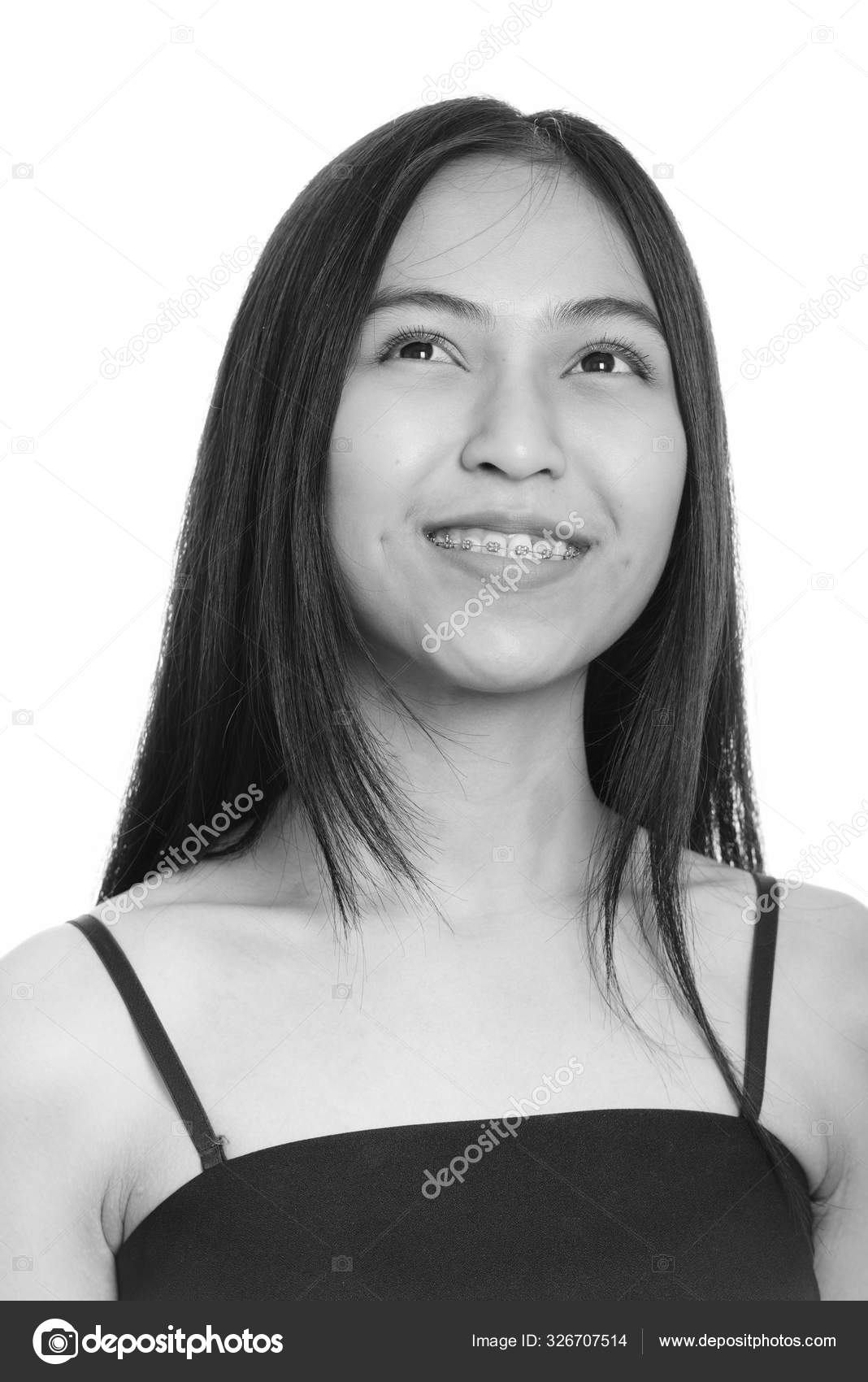 Face of young happy Asian teenage girl smiling while thinking — Stock ...